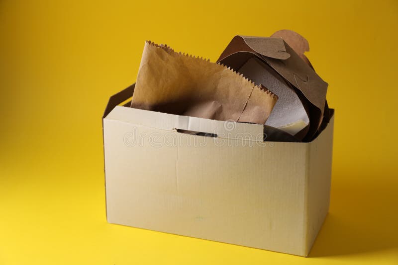 Box with Waste Paper on Yellow Background Stock Photo - Image of ...