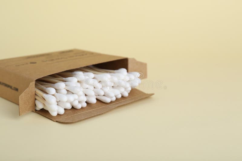 Box with Wooden Cotton Buds on Beige Background. Space for Text Stock ...
