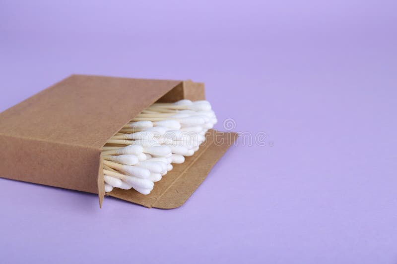 Box with Wooden Cotton Buds on Violet Background. Space for Text Stock ...