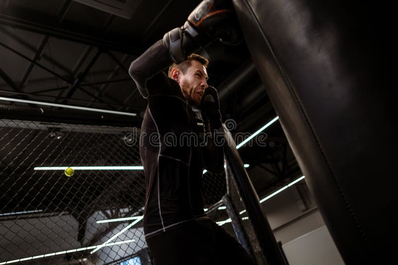 Boxer Delivering Powerful Right Hook on Heavy Bag in Gym Stock Image ...