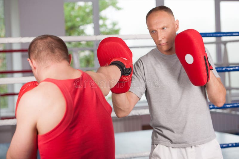 Boxer and His Coach Doing Some Punching with Bag. Stock Image - Image ...