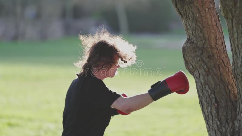 Young Man Boxing with Red Gloves in a Park Stock Footage - Video of ...