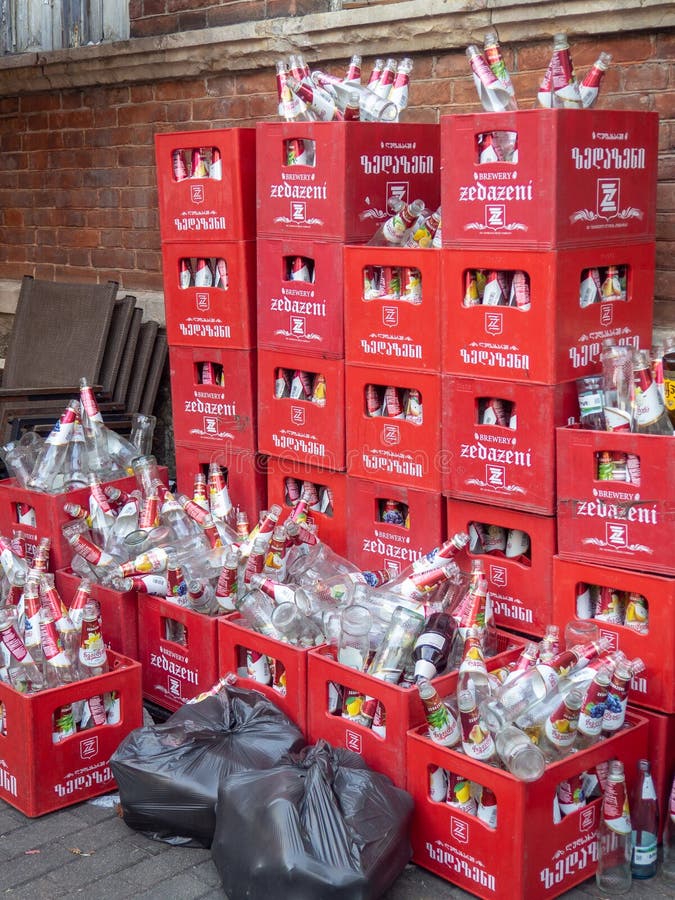 Boxes with Empty Glass Bottles. Bottles in Yellow Boxes in the Backyard ...
