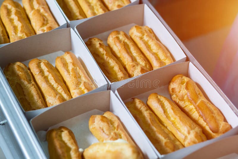 Boxes with Eclairs on Conveyor. Stock Photo - Image of light, paper ...