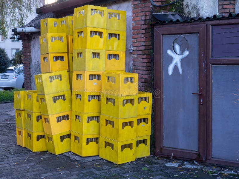 Boxes with Empty Glass Bottles. Bottles in Yellow Boxes in the Backyard ...