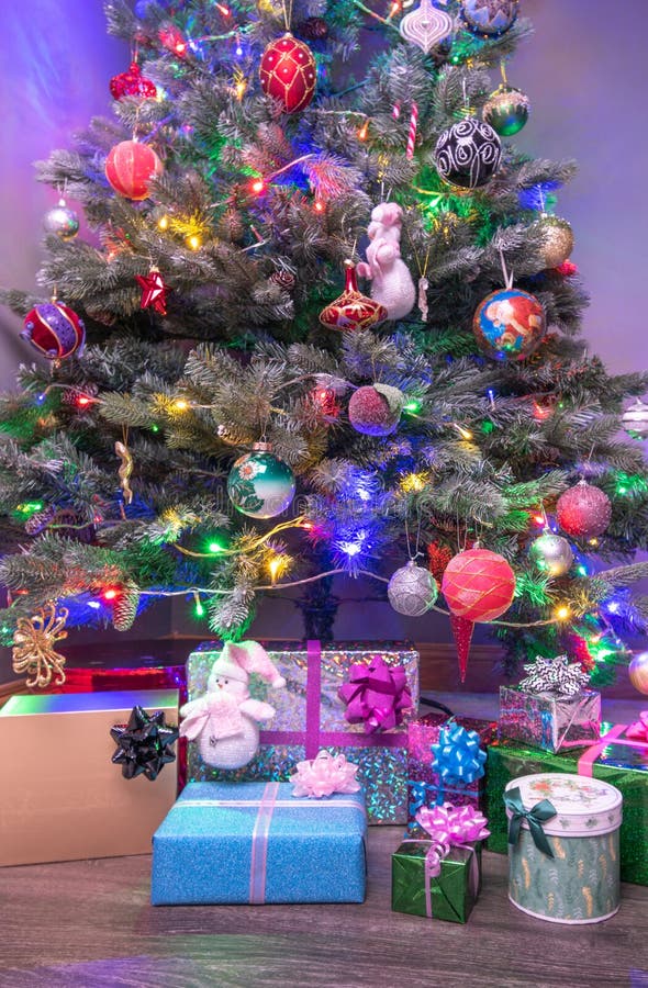 Boxes of Presents Under Decorated Artificial Christmas Tree. Stock ...