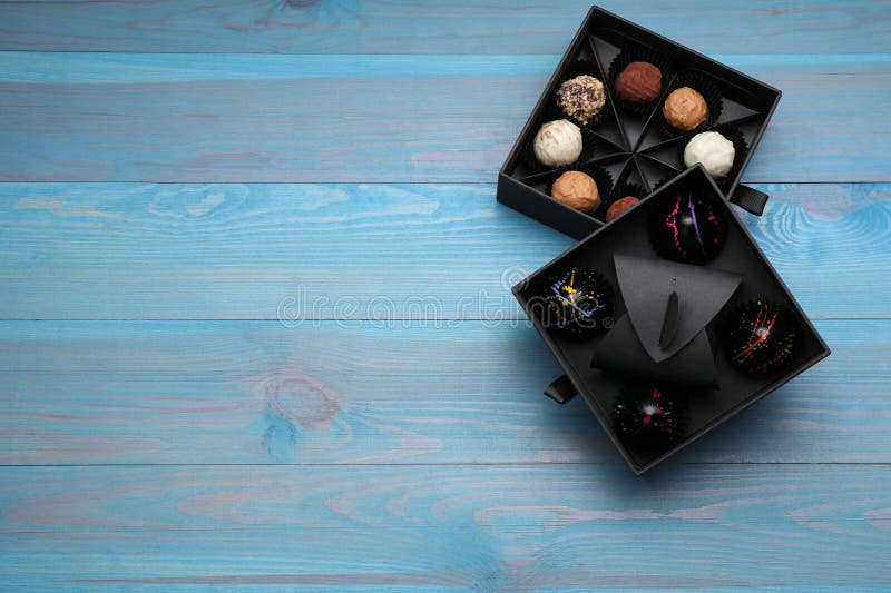 Boxes of Tasty Chocolate Candies on Light Blue Wooden Table, Flat Lay ...