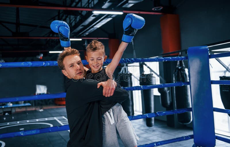Boxing Coach Standing in the Ring with Boy and Celebrating Victory ...