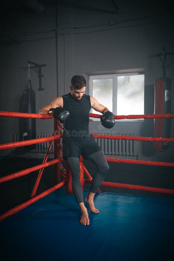 In a Boxing Ring Athletic Man Have a Break Time after a Boxing Workout ...