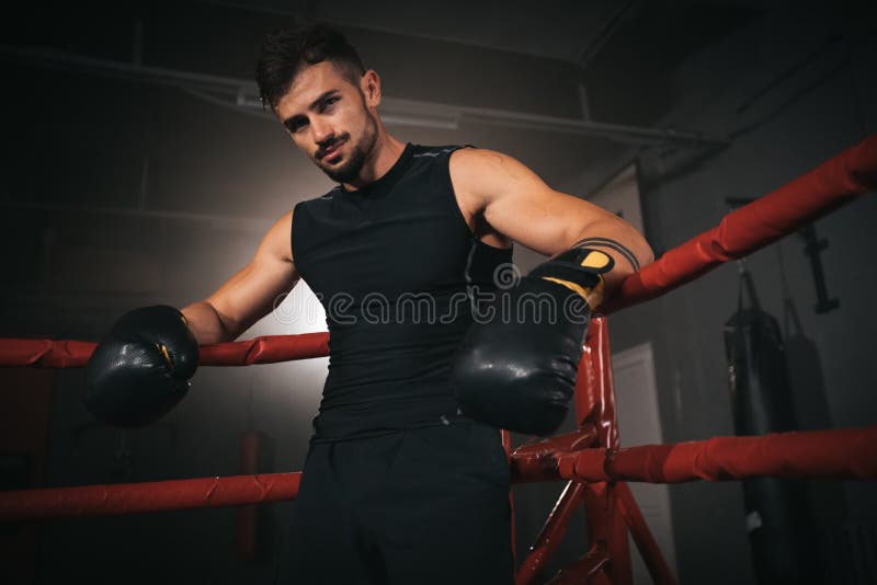 In a Boxing Ring Athletic Man Have a Break Time after a Boxing Workout ...