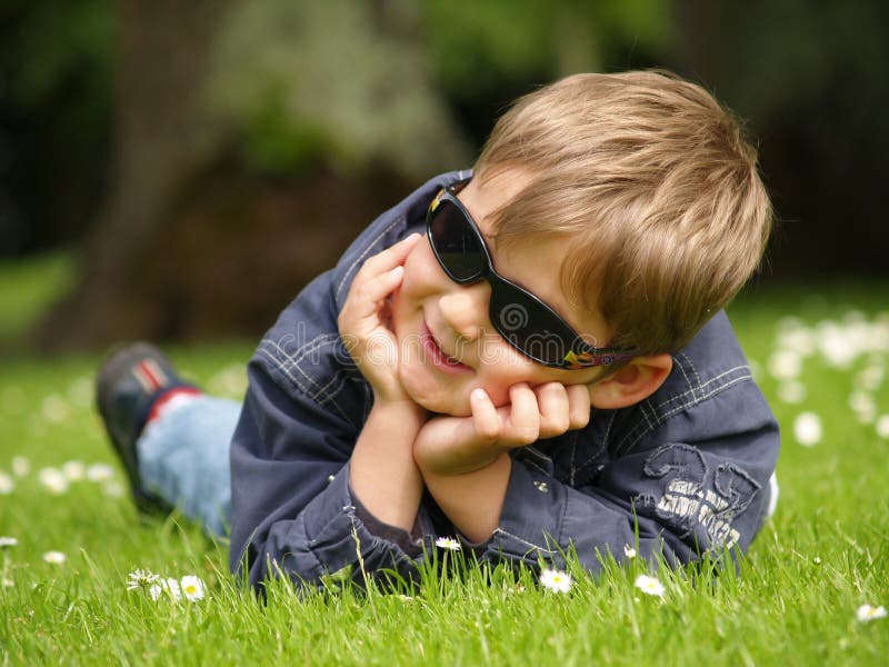 Boy stock photo. Image of outside, face, dreaming, grass - 2575326
