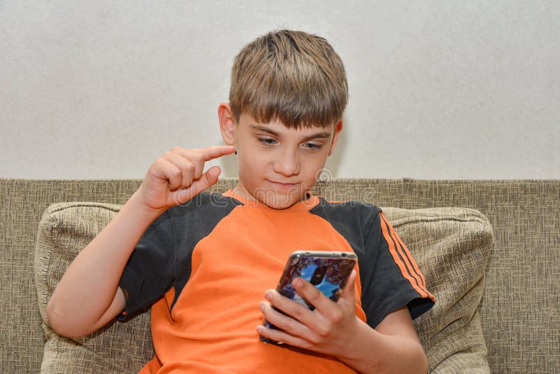 A Boy with Anger and Discontent Turns Off the Smartphone after a Bad ...