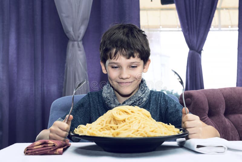 Boy is Appetizing Eats a Large Italian Spaghetti Stock Photo - Image of ...