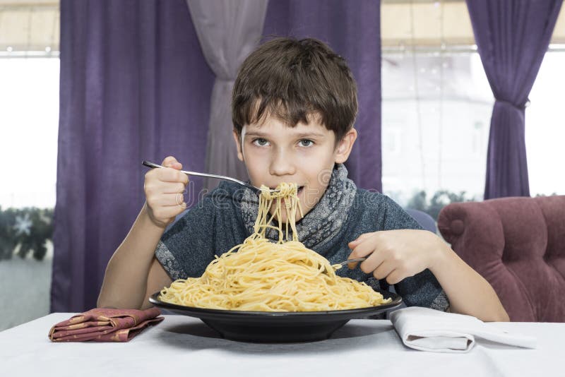 Boy is Appetizing Eats a Large Italian Spaghetti Stock Photo - Image of ...
