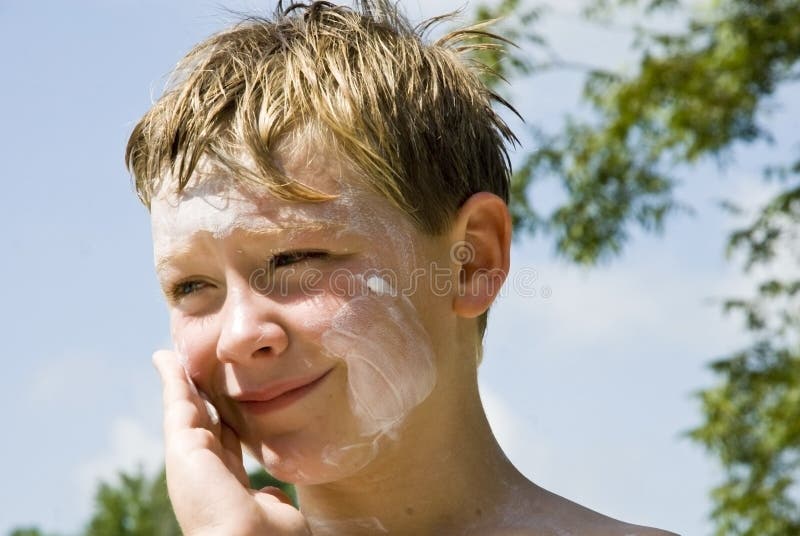 Boy Applying Sunscreen stock image. Image of smiling, camp - 5943245