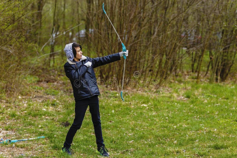Boy Archer Shooting with His Bow at an Outdoor Stock Photo - Image of ...