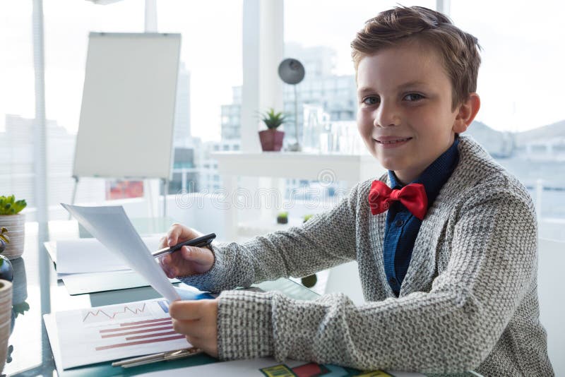 Boy As Business Executive Holding Document in Office Stock Image ...