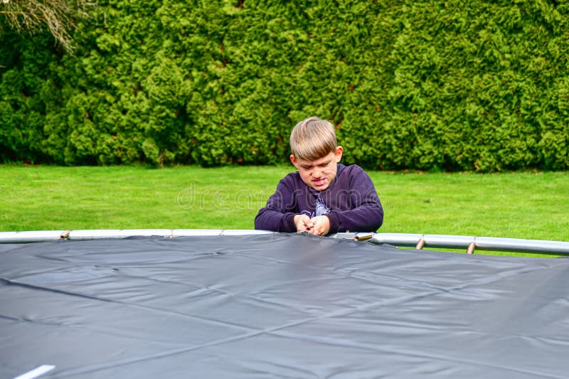 The Boy Assembles a New Trampoline and Stretches the Springs To Jump ...