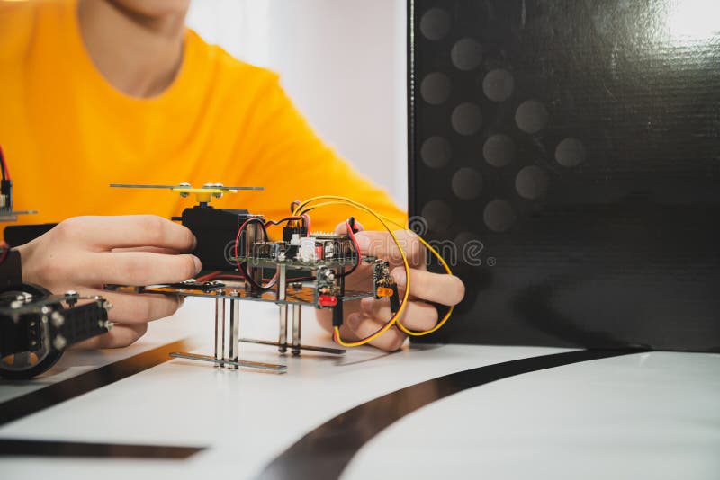 Boy Assembles a Programmable Self-propelled Toy Stock Image - Image of ...