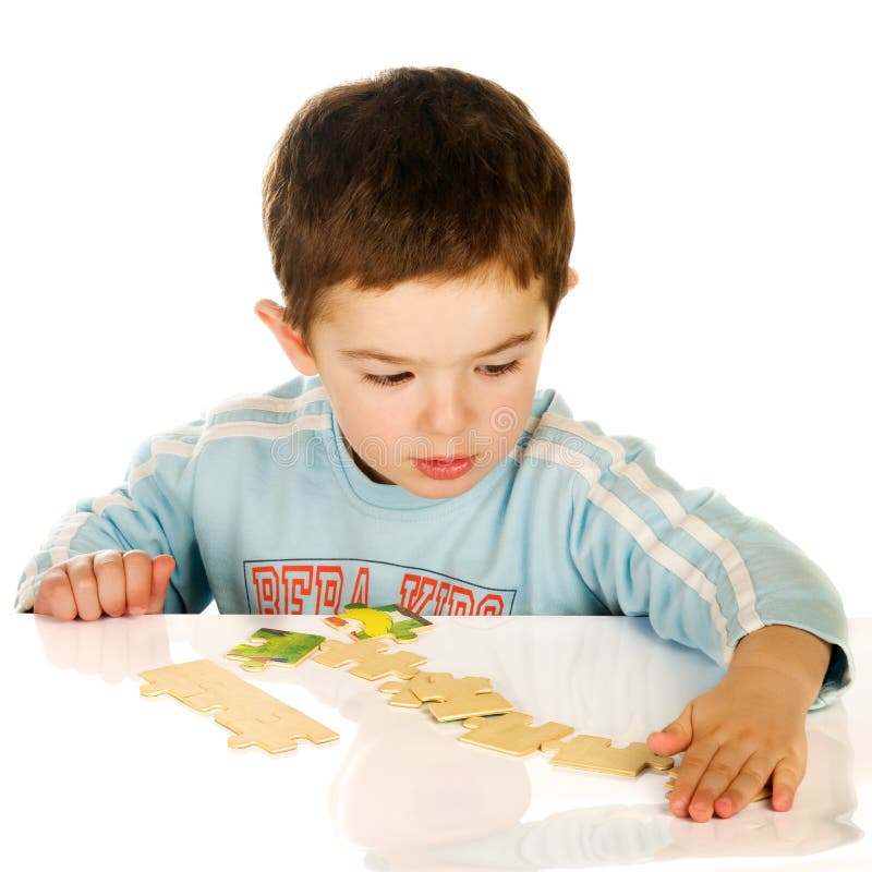 Boy assembling puzzle stock image. Image of difficulty - 9303631