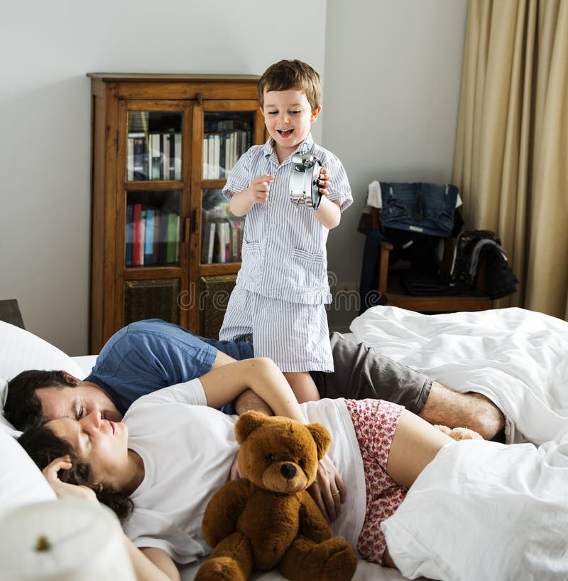 Boy Awakening Dad and Mom in the Bebroom Stock Image - Image of blanket ...
