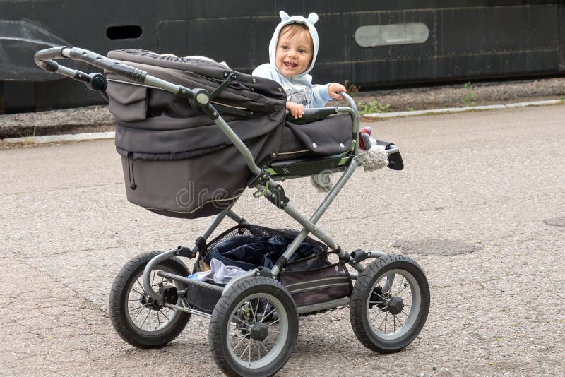 A Boy in a Baby Stroller with Funny Ears Stock Image - Image of fitness ...