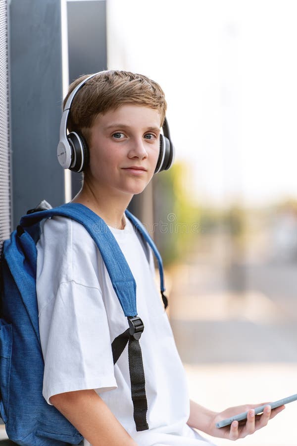 Teenage Boy Looking at Camera while Sitting on Grass with a Notebook ...