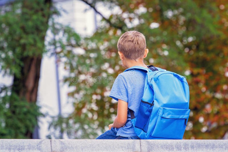 Boy with Backpack Sitting after School Outdoors Stock Photo - Image of ...