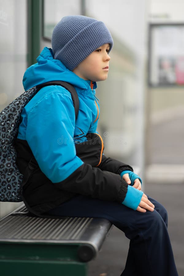 Boy with a Backpack Waits for a Tram at a Stop in the Fog on the Way To ...