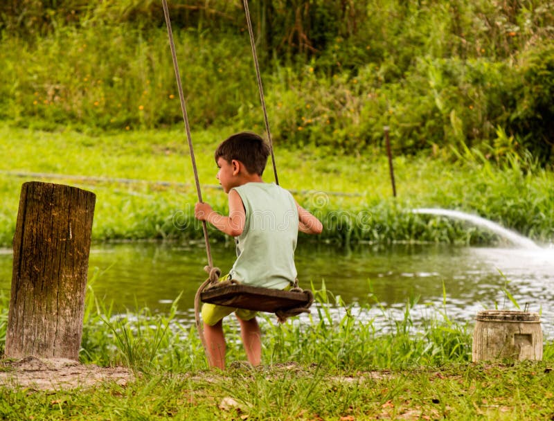 A boy in the balance stock photo. Image of grass, landscape - 273776704