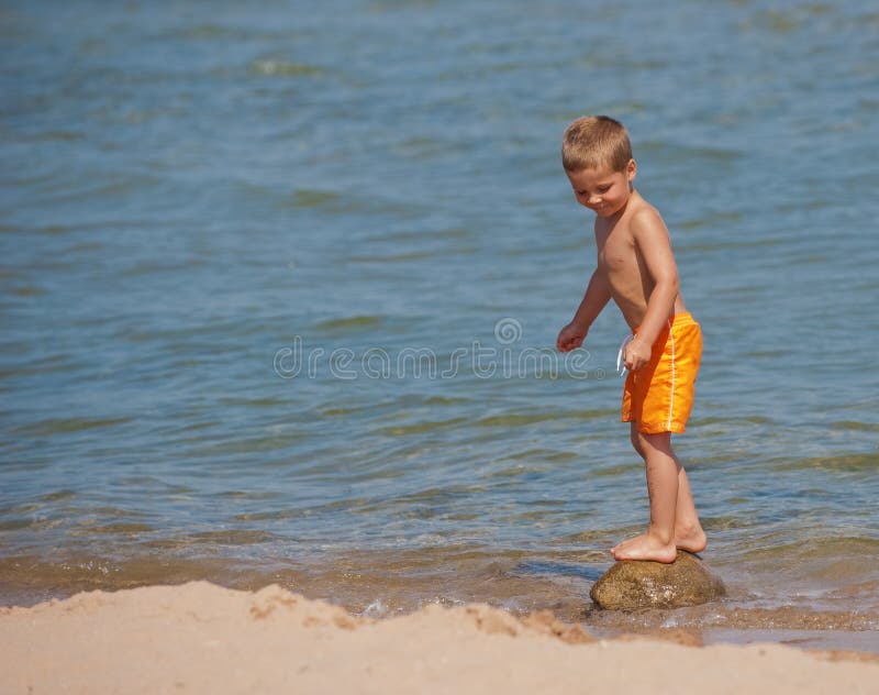 Boy Balancing on a Rock stock image. Image of steady - 10963455