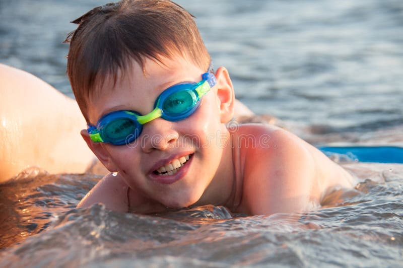 Boy bathing in the sea stock image. Image of goggles - 75576925