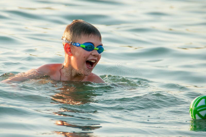 Boy bathing in the sea stock photo. Image of play, beaches - 76788724