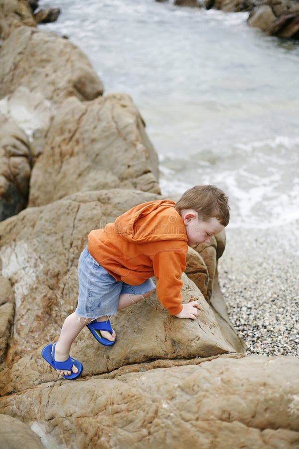 Boy at the Beach stock image. Image of childhood, climbing - 35310209
