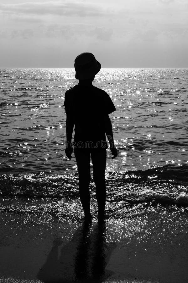 The Boy on the Beach Looking into the Distanc Stock Image - Image of ...