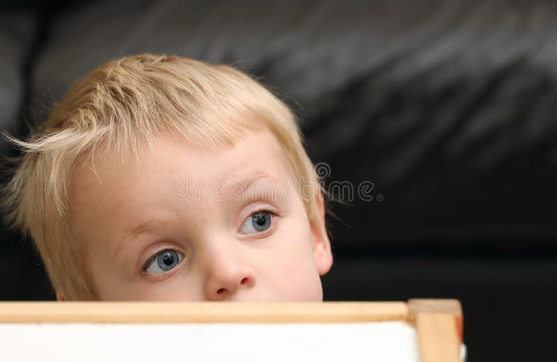 Boy behind a table stock image. Image of toddler, male - 23808089
