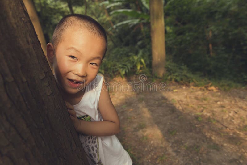 Child Hiding Behind Tree