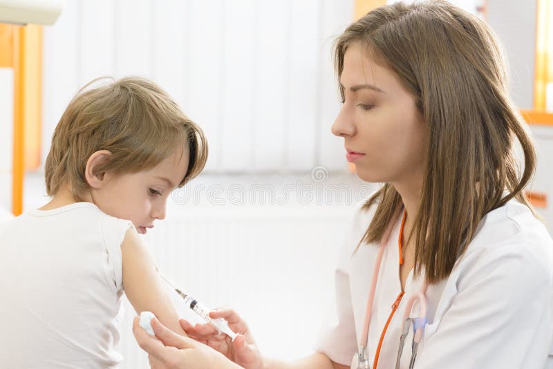 Boy Being Injected at Clinic Stock Photo - Image of disease, cabinet ...