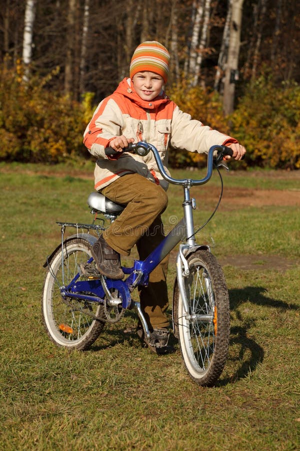 Boy on Bicycle in Autumn Park on Sunny Day Stock Photo - Image of ...