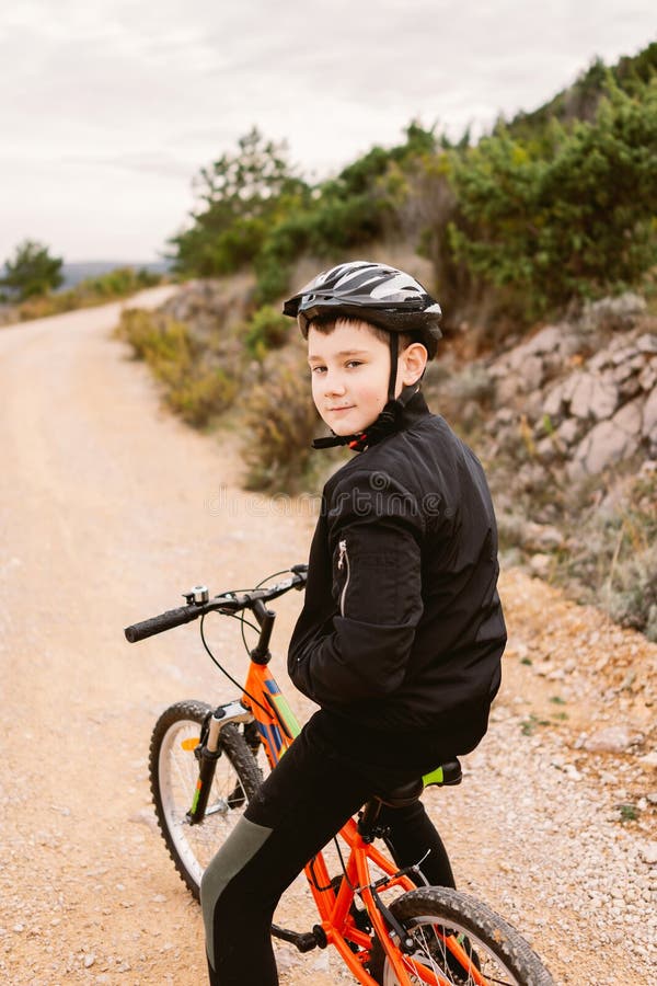 Boy on a bicycle stock image. Image of ride, male, helmet - 233980173