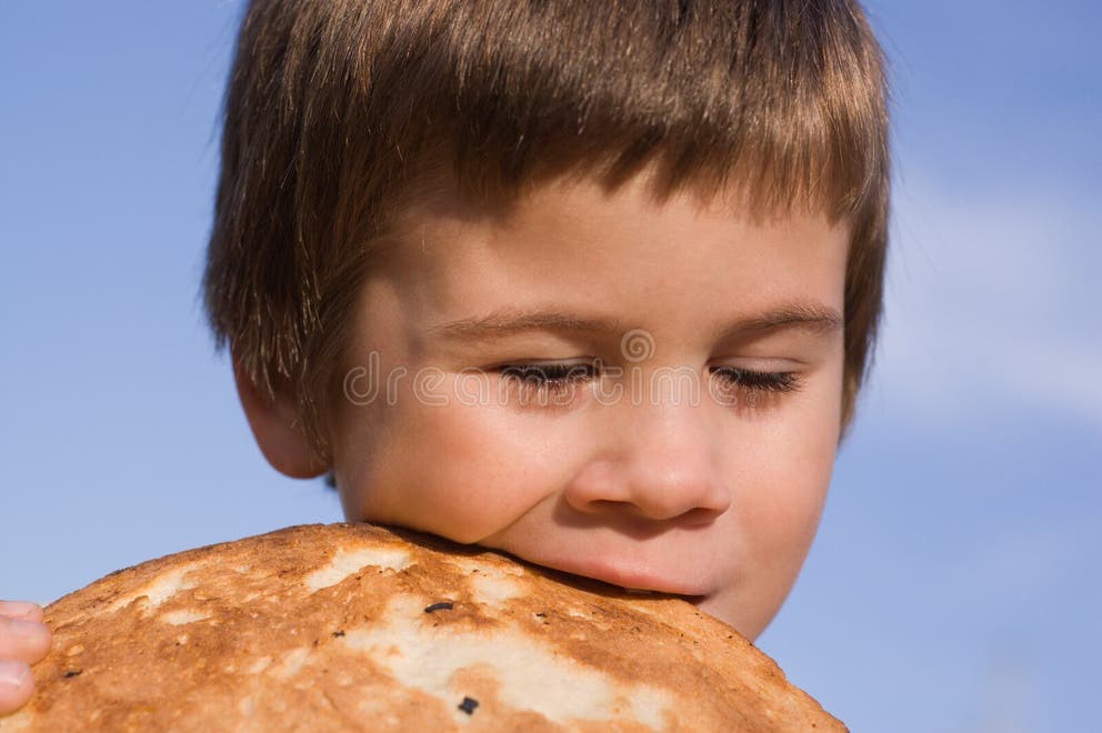 Boy bites bread stock photo. Image of bread, food, appetite - 4011780