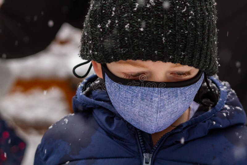 A Boy with a Black Hat an a Mask in the Snow Stock Image - Image of ...