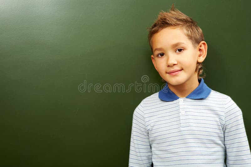 Boy at blackboard stock photo. Image of looking, diligent - 23973946