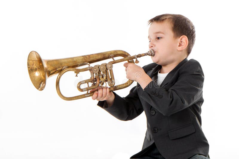 Boy blowing into a trumpet stock image. Image of background - 91623677