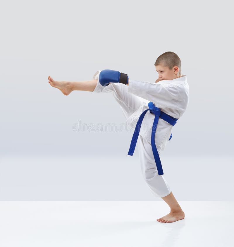 Boy with Blue Belt and Overlays on the Hands is Beating Kicking Stock ...