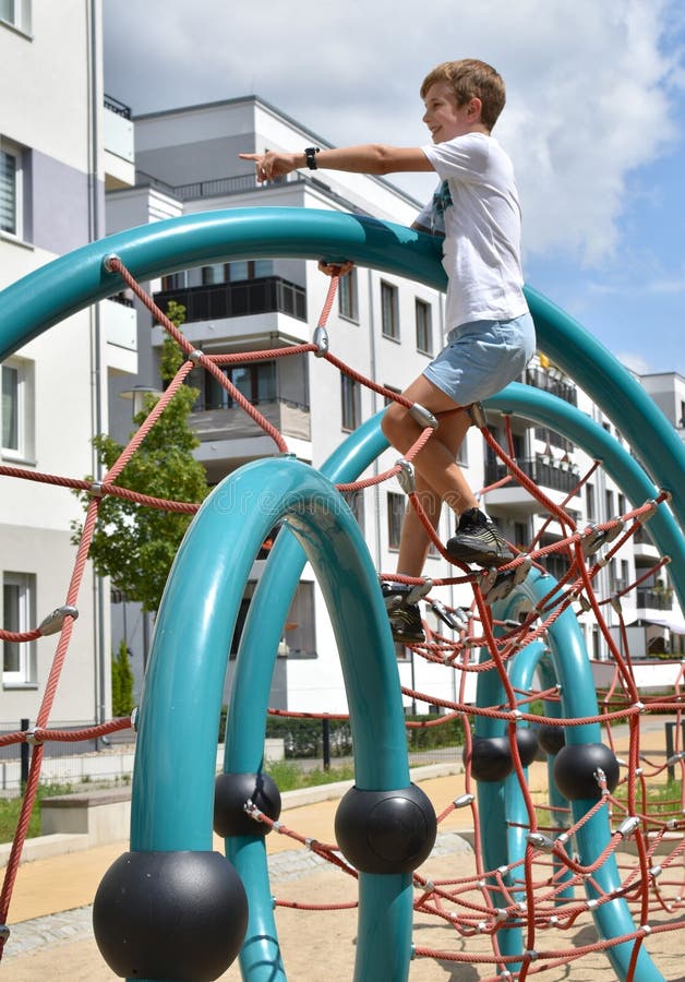 A Boy in Blue Shorts Points His Finger Forward while Standing on the ...