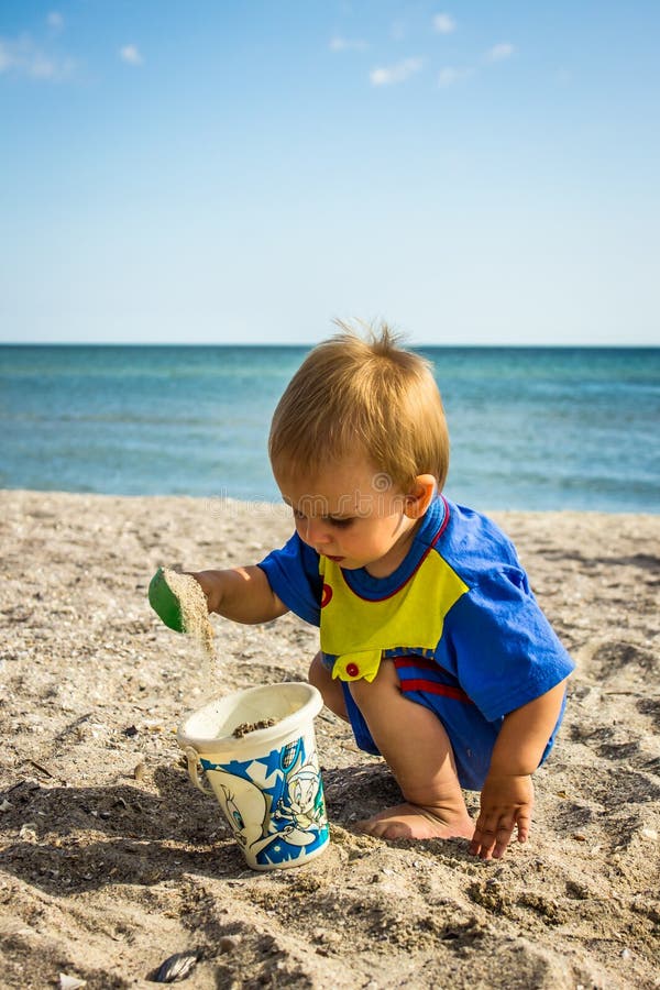 A Boy in a Blue Suit Played on the Beach Stock Photo - Image of ...