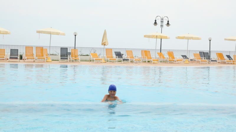Boy in Blue Swimming Trunks and Bathing Cap Slide Stock Footage - Video ...