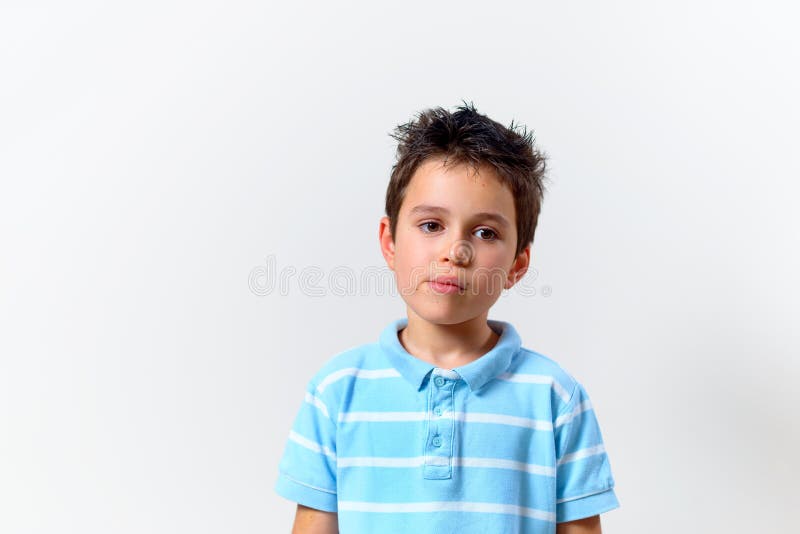 A Boy in a Blue T-shirt with a Brooding Face Looks Somewhere from the ...