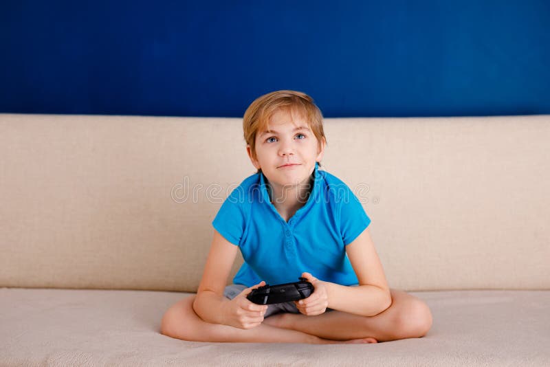 Boy in Blue T-shirt Holding Video Game Controller Having Fun Playing ...